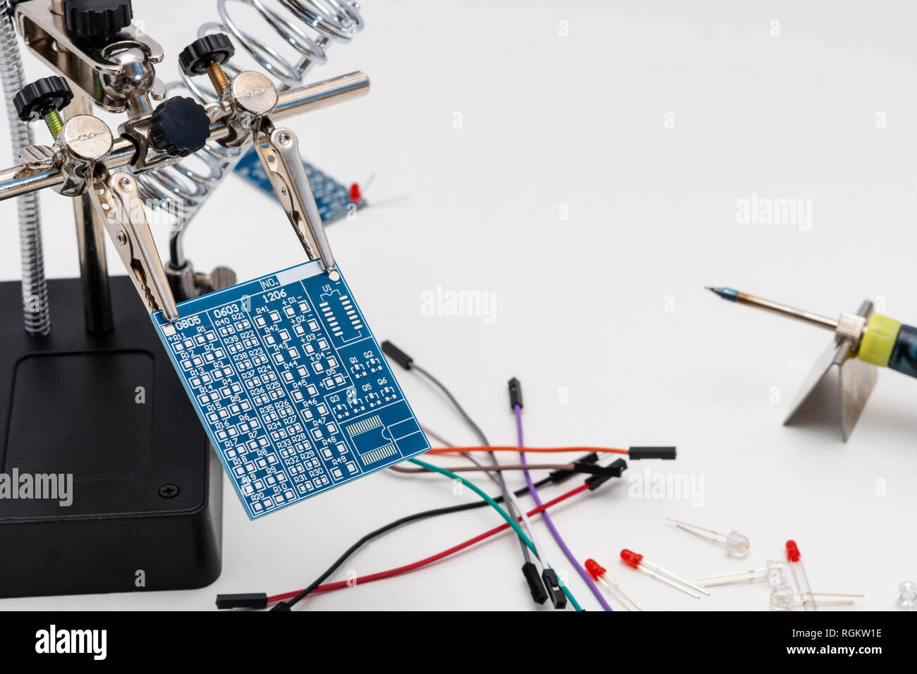 Circuit board in soldering helping hands (third hand or auxiliary clip ...