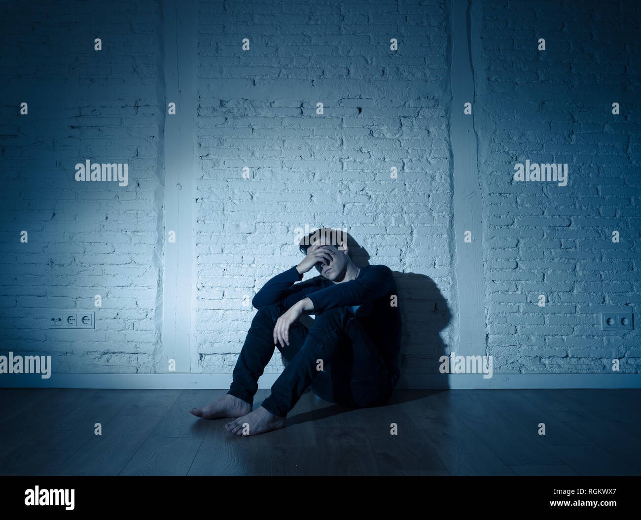 Portrait of sad depressed young man crying devastated feeling hurt ...