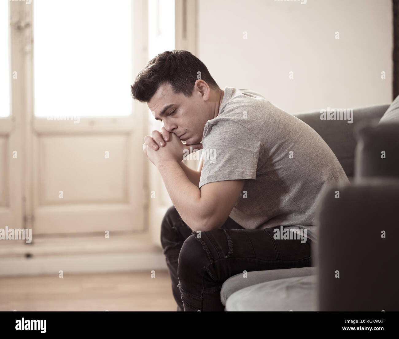 Portrait of young man felling depressed and desperate crying alone in ...