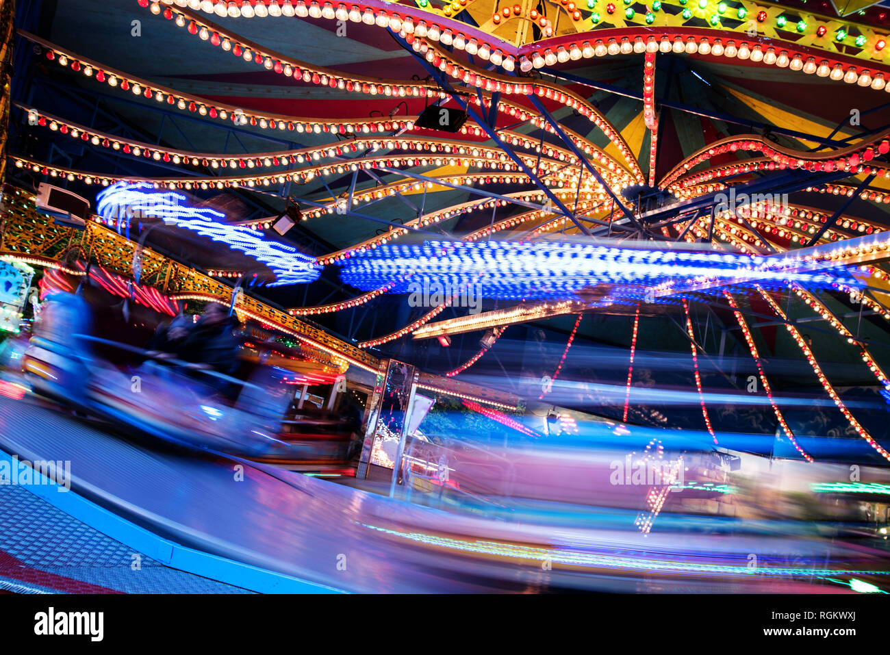 fast funfair ride carousel at the christmas market, long exposure with ...