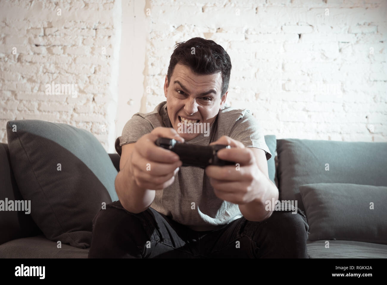 Portrait of young student man spending time playing video games using ...