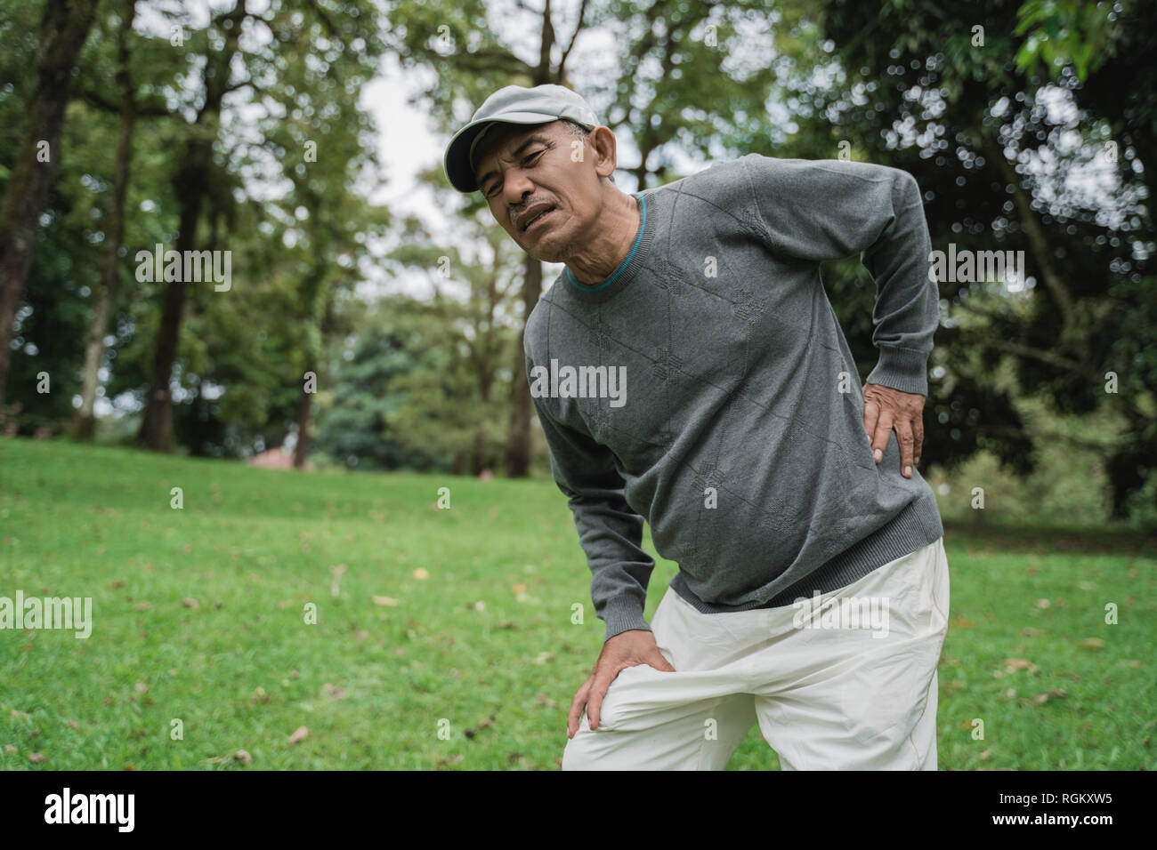 old man having back pain while in the park Stock Photo - Alamy