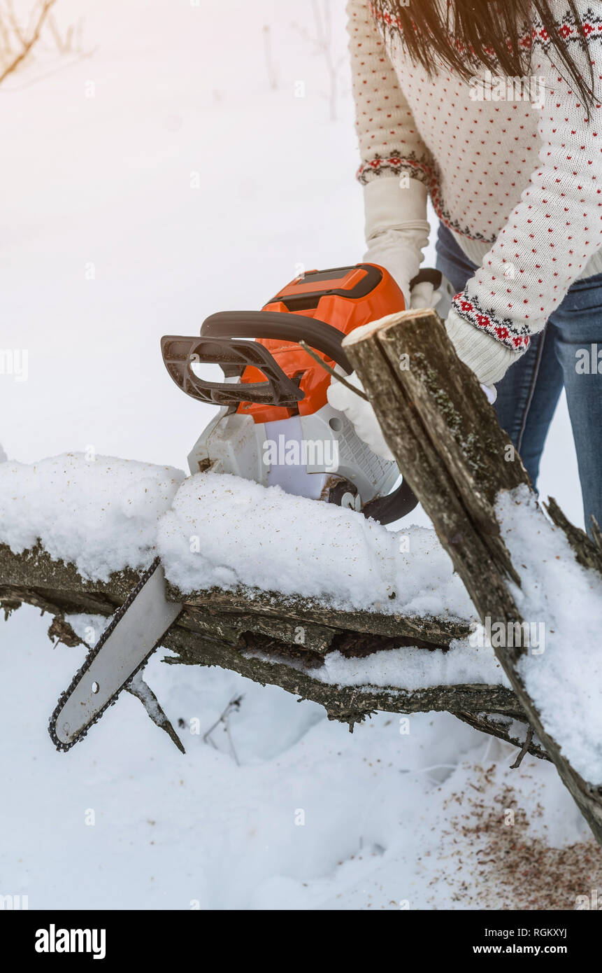 Woman sawing dry tree chainsaw hi-res stock photography and images - Alamy