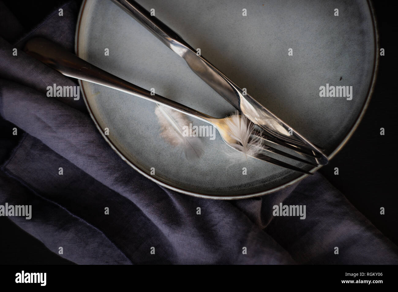 Table setting with feather for festive Easter dinner on rustic ...