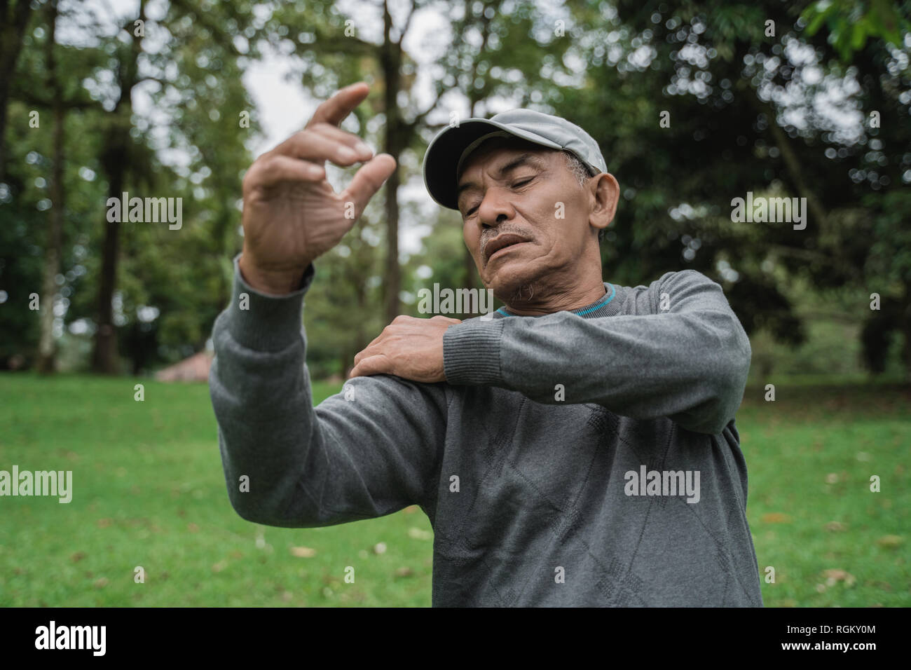 senior male asian having sore shoulder and pain on his joint Stock ...