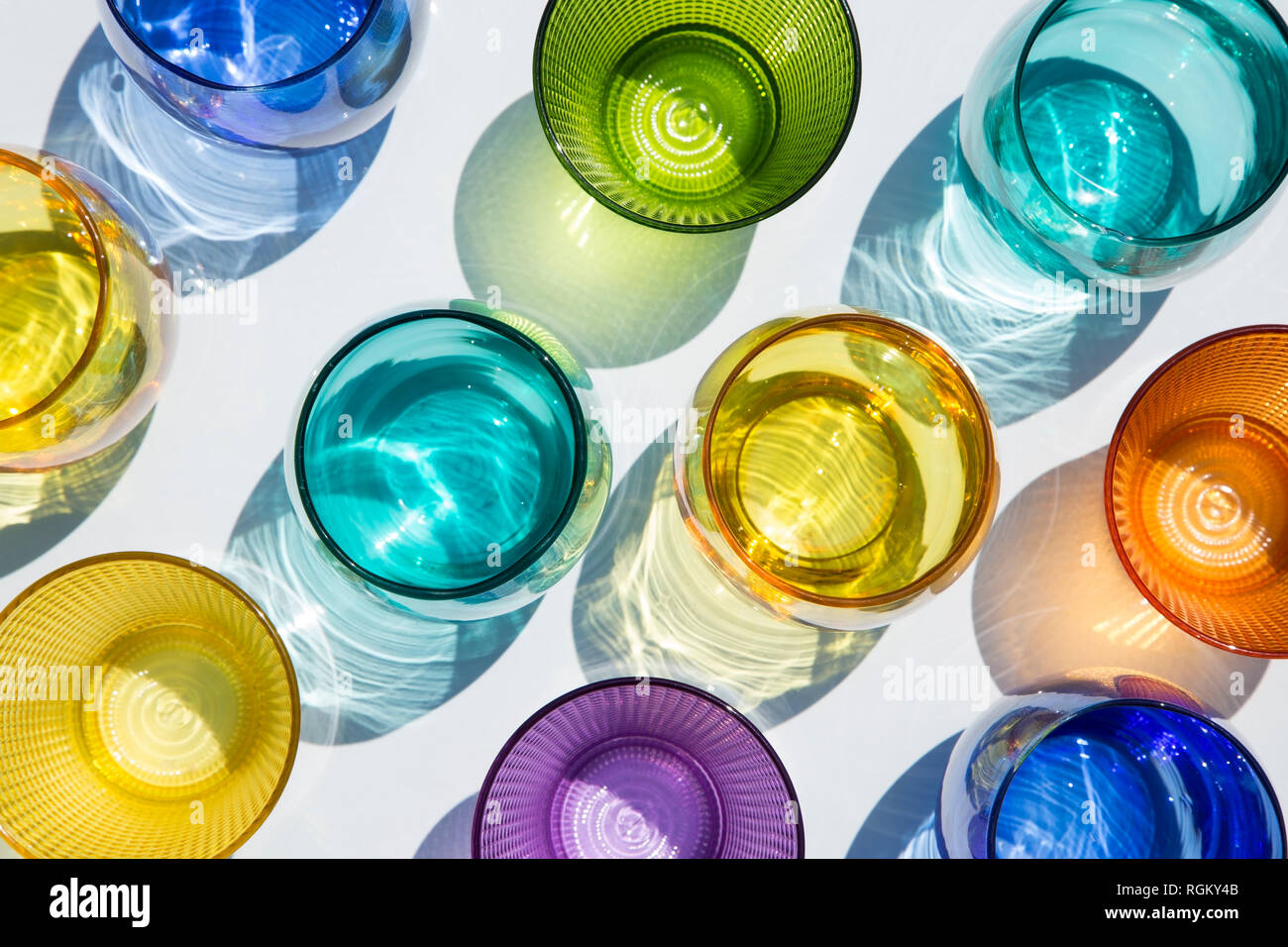 Colorful glasses on bright light with the shadows - top view Stock ...