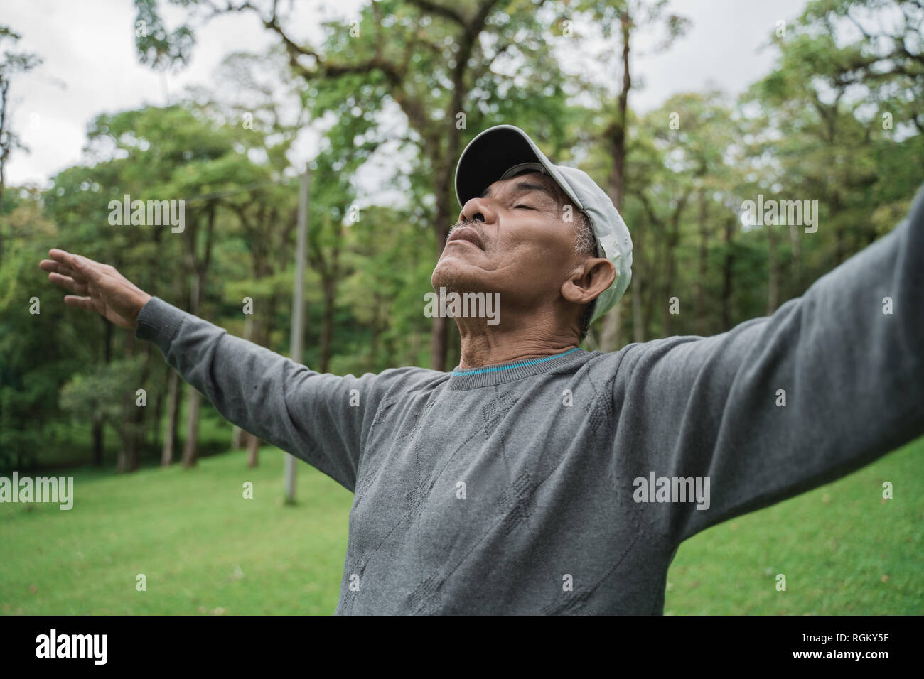 senior people take a deep breath stretch out and raise arm Stock Photo ...