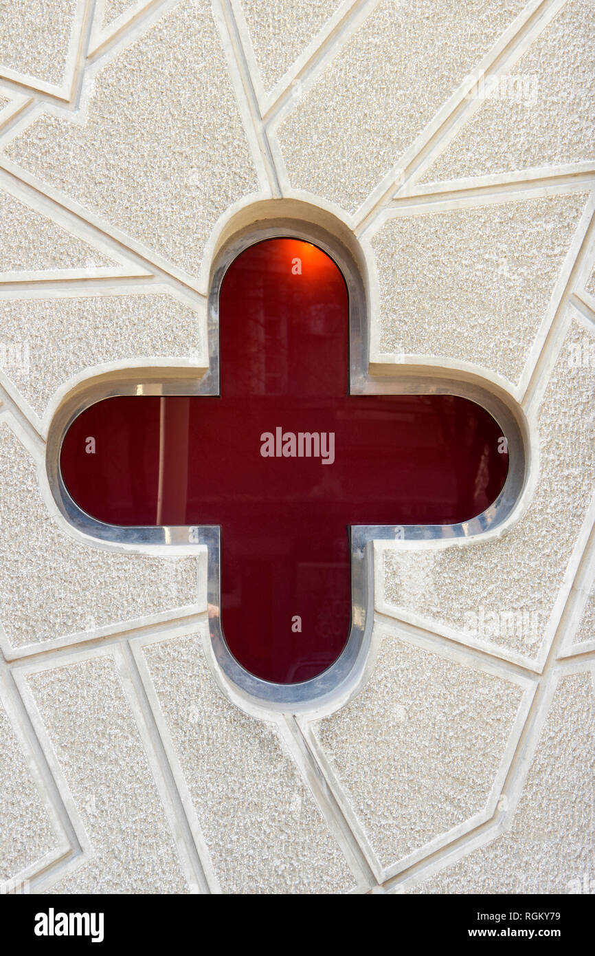 Red cross shape window at the white stone facade Stock Photo - Alamy