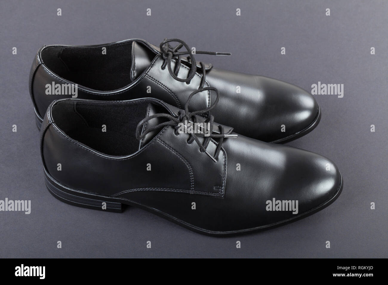 Close up picture of mens footwear. Black leather elegant shoes on grey ...