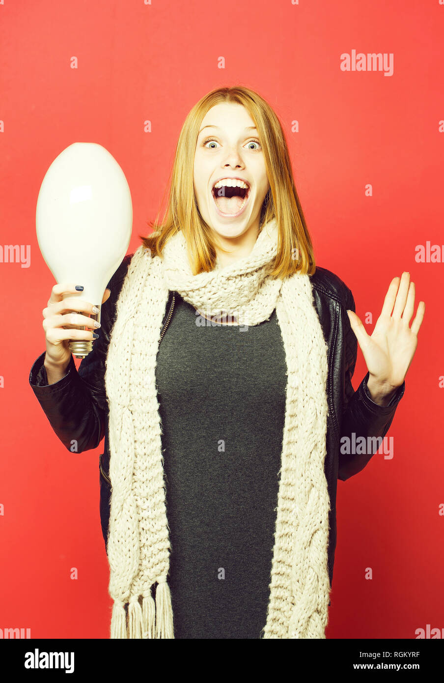 Astonished pretty girl with bulb Stock Photo - Alamy