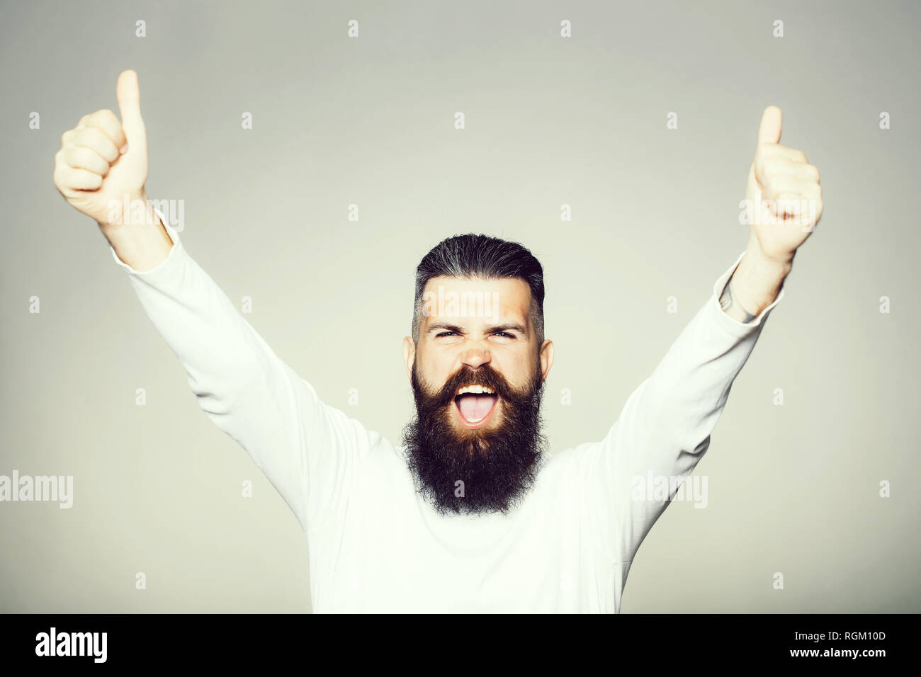 Bearded man with super gesture Stock Photo - Alamy
