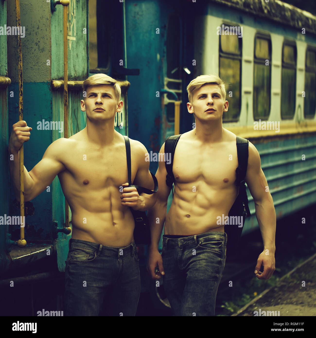 Muscular guys near railway train Stock Photo - Alamy