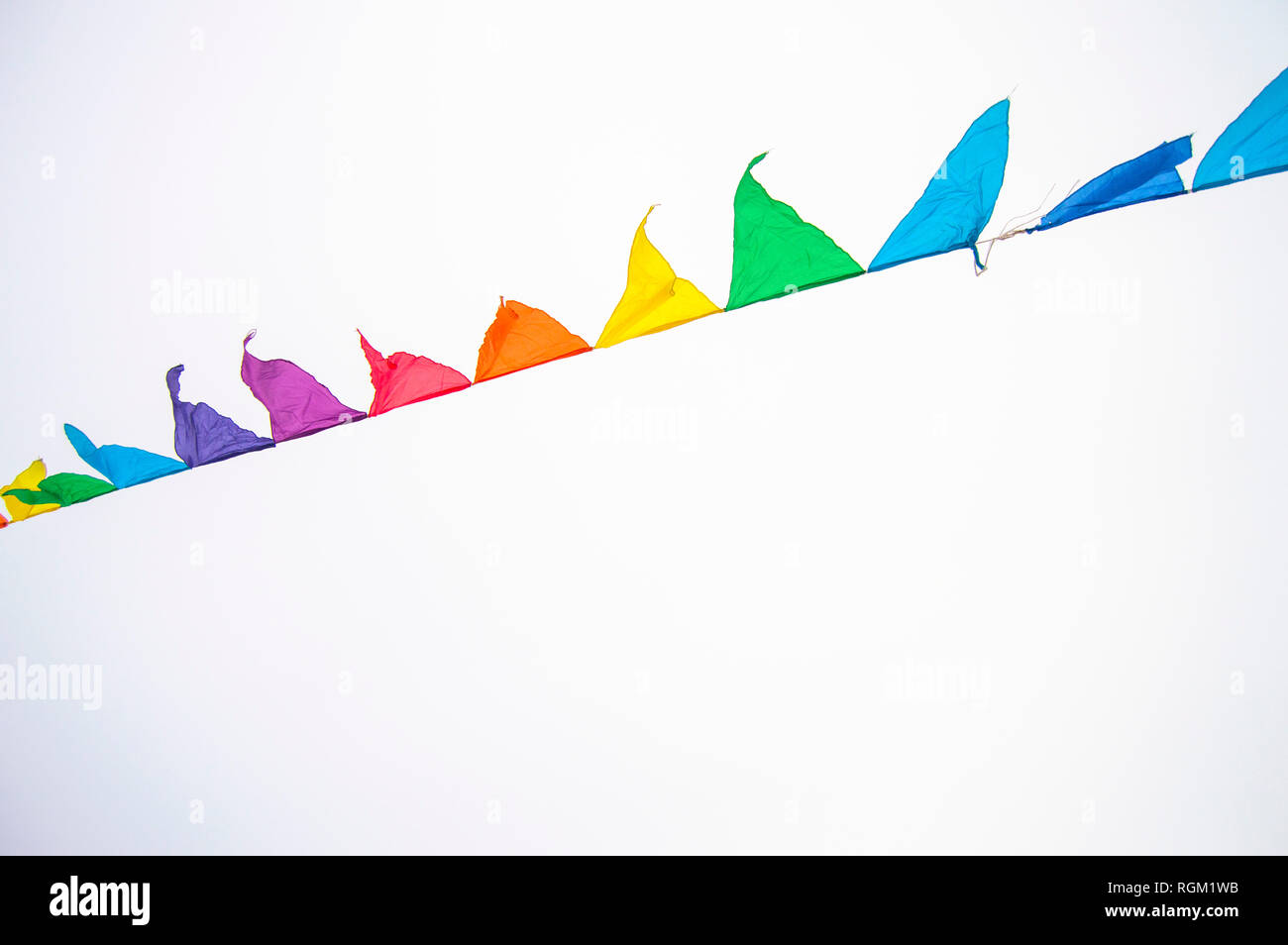 Colorful multicolored triangular flags, isolated on a white background ...