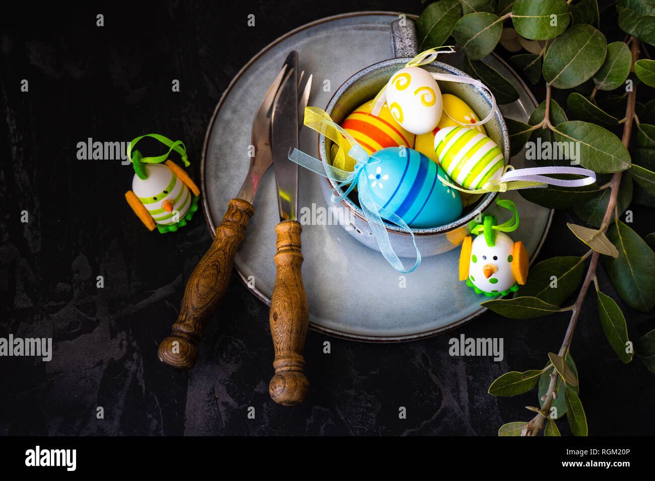Table setting for festive Easter dinner on rustic background with copy ...