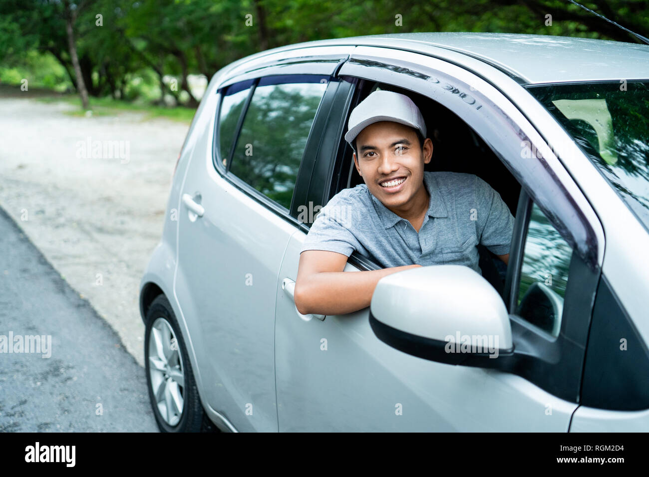 asian driver look out from the open window with smile Stock Photo - Alamy