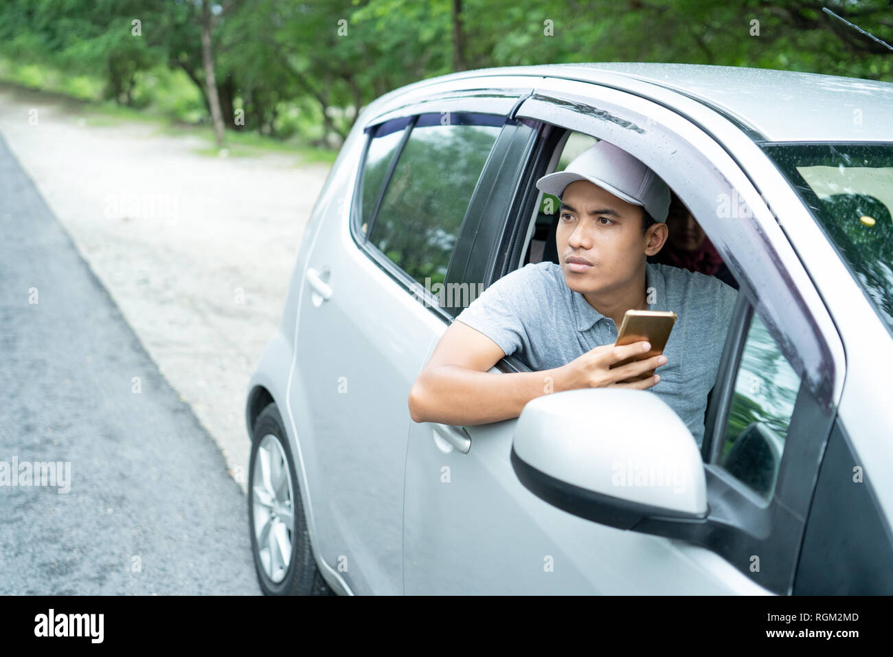 male driver searching location when looking for destination with ...