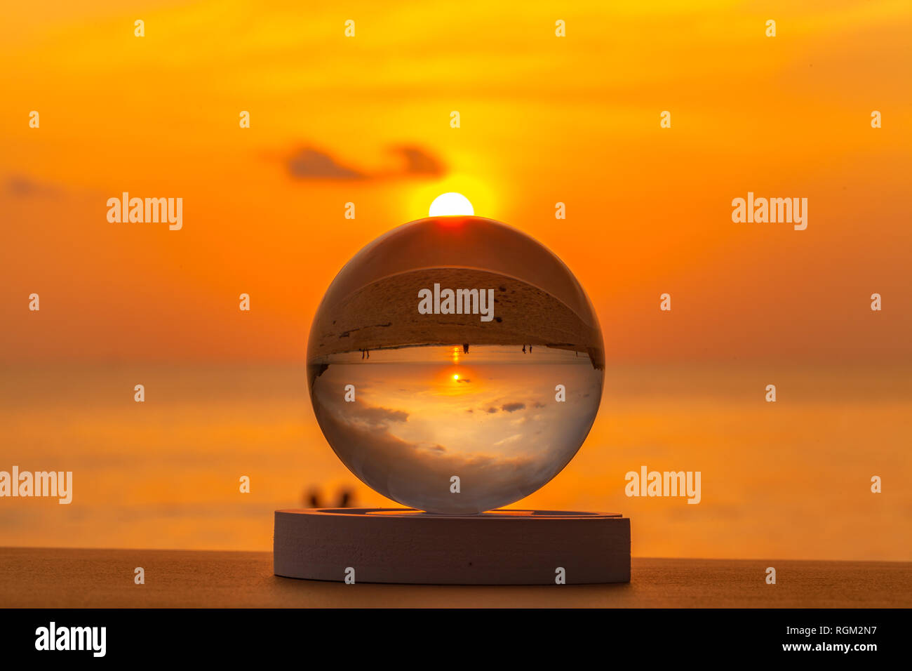 crystal glass ball sphere reveals sunrise seascape with spherical ...