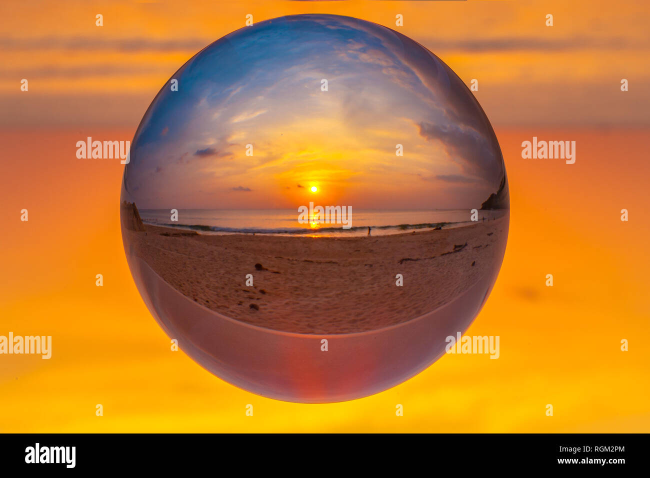 crystal glass ball sphere reveals sunrise seascape with spherical ...