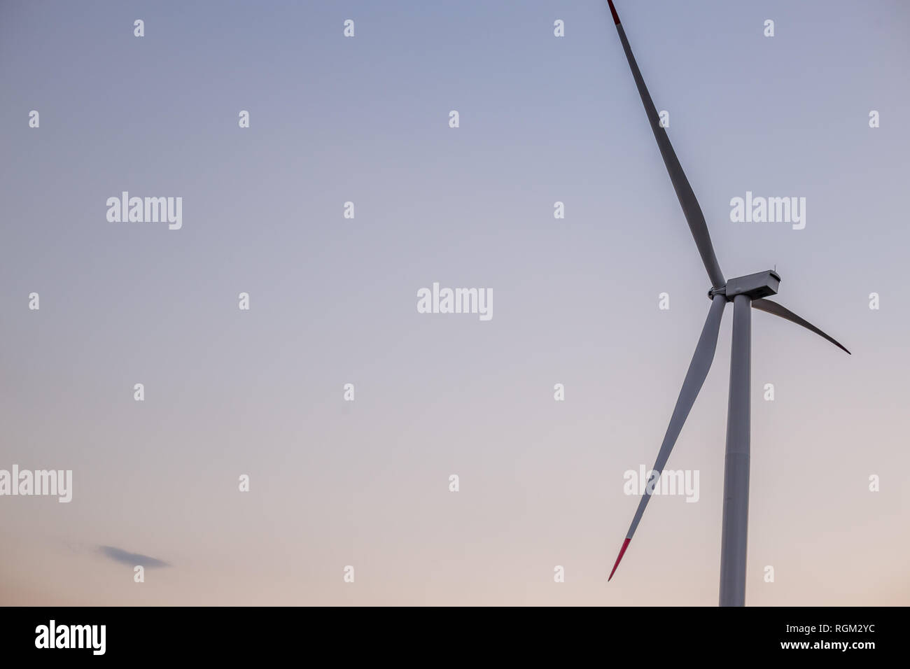 One windmill turbine top at blue cloudy sunset sky Stock Photo - Alamy