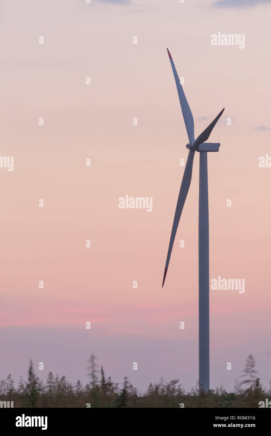 One windmill turbine at red purple sunset sky Stock Photo - Alamy