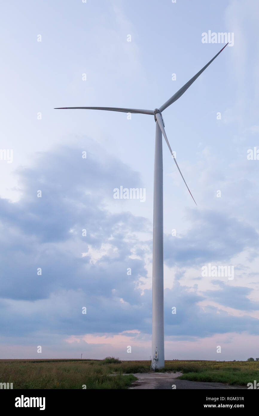 One windmill turbine at blue and purple cloudy sunset sky Stock Photo ...