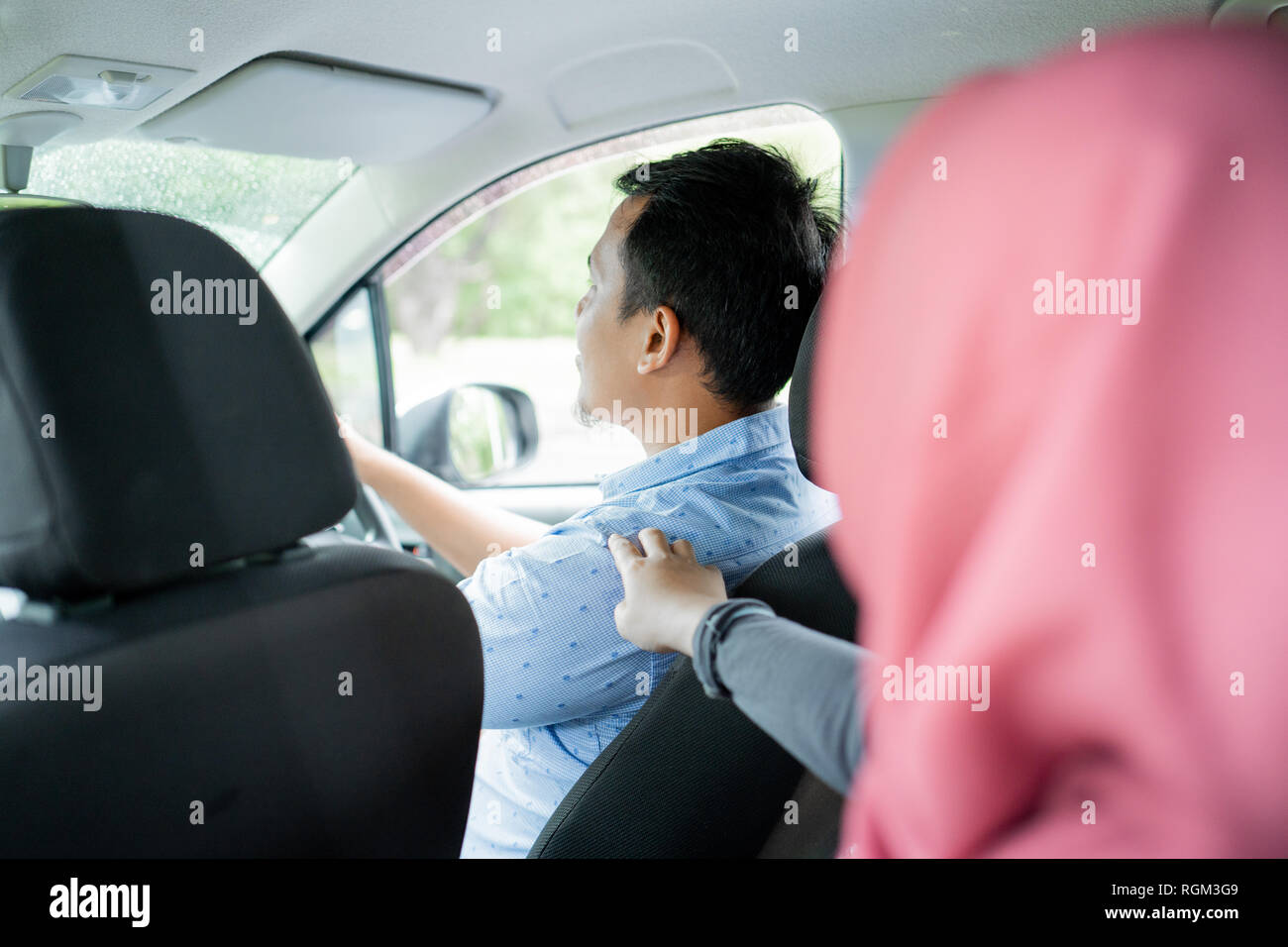 asian taxi driver ignored a touch by hijab passenger Stock Photo - Alamy