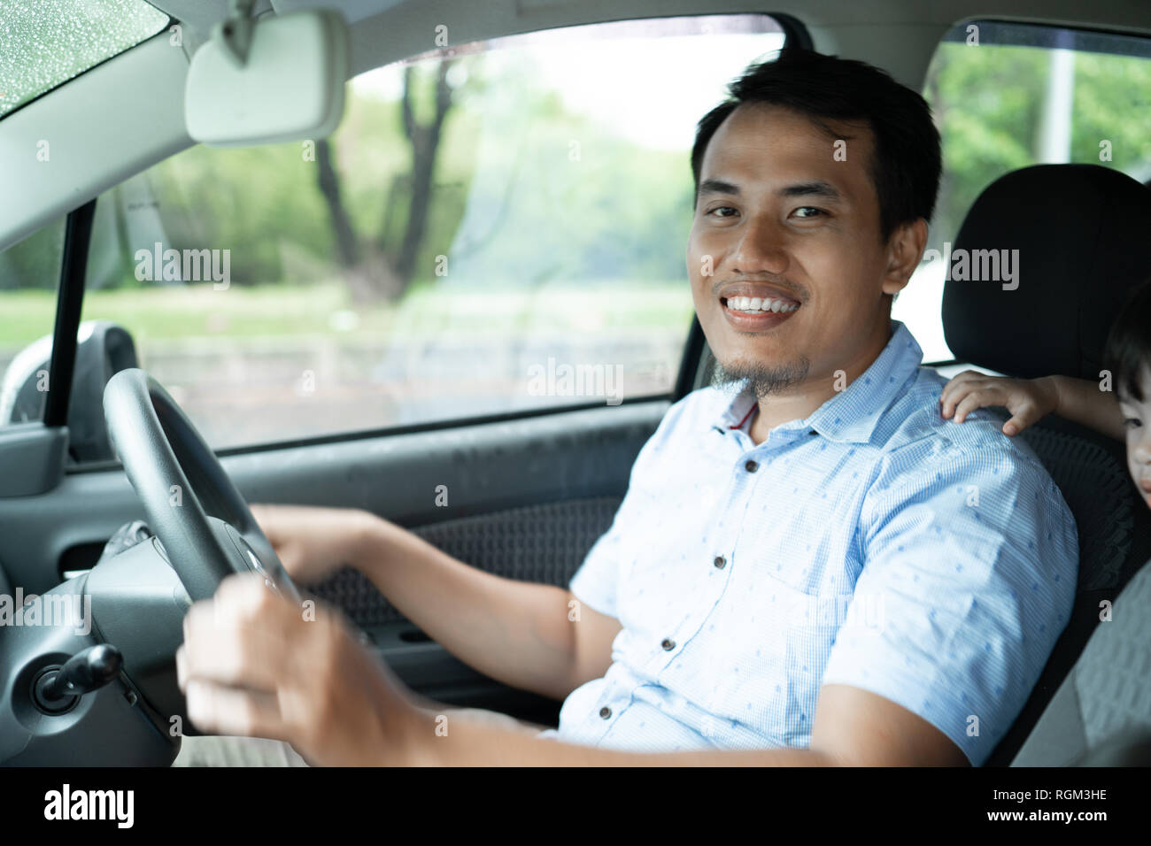 young asian driver smile to the camera when drive a car Stock Photo - Alamy