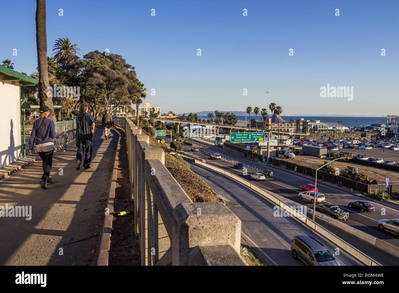 Pedestrians walking over Pacific Coast Highway by Santa Monica Pier ...