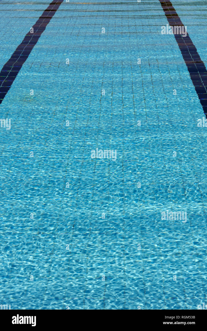 Patterns formed by sunlight on the water in an outdoor swimming pool ...
