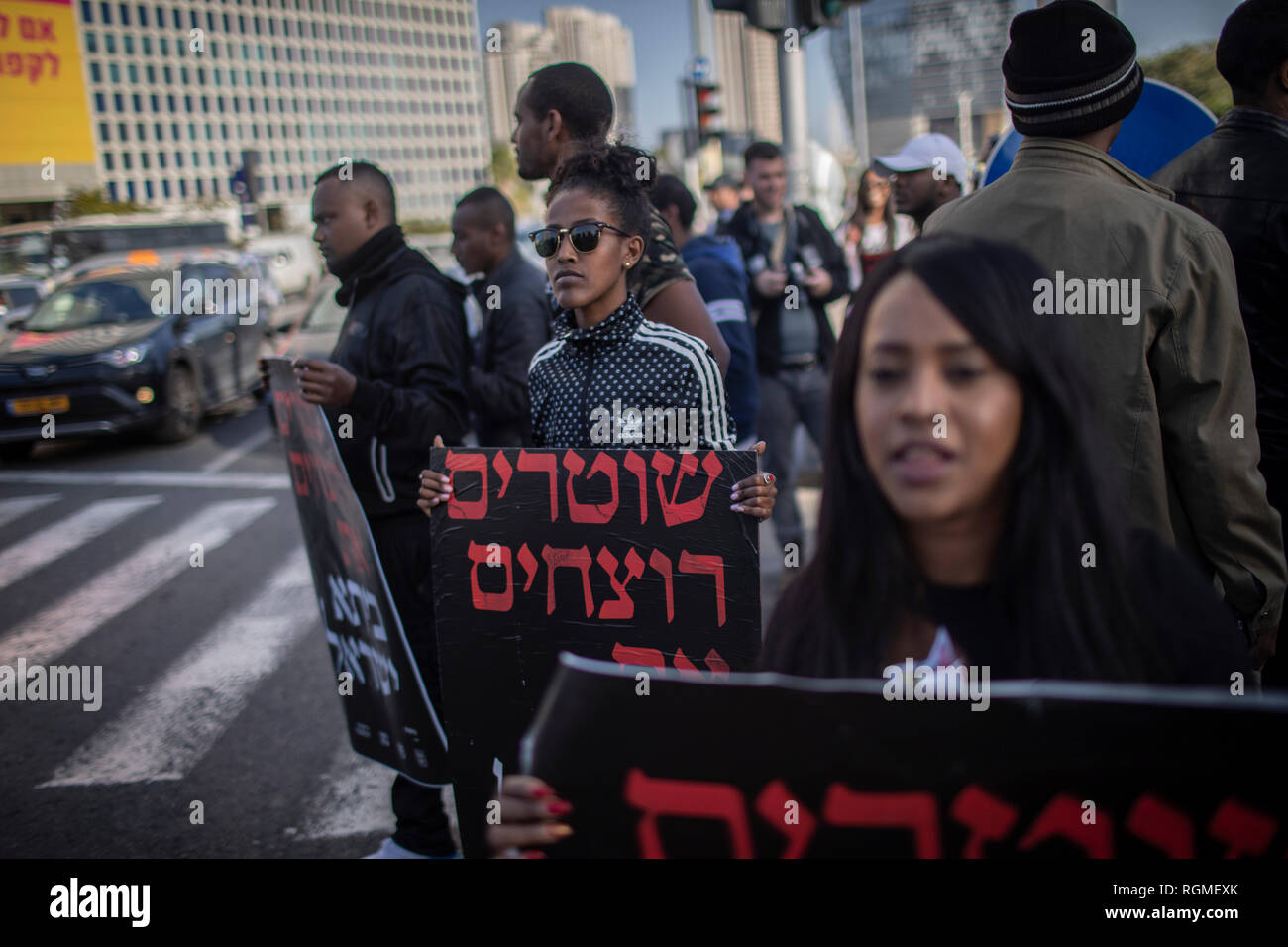 Tel Aviv, Israel. 30th Jan, 2019. Ethiopian-Israelis and their supporters hold placards during a ...