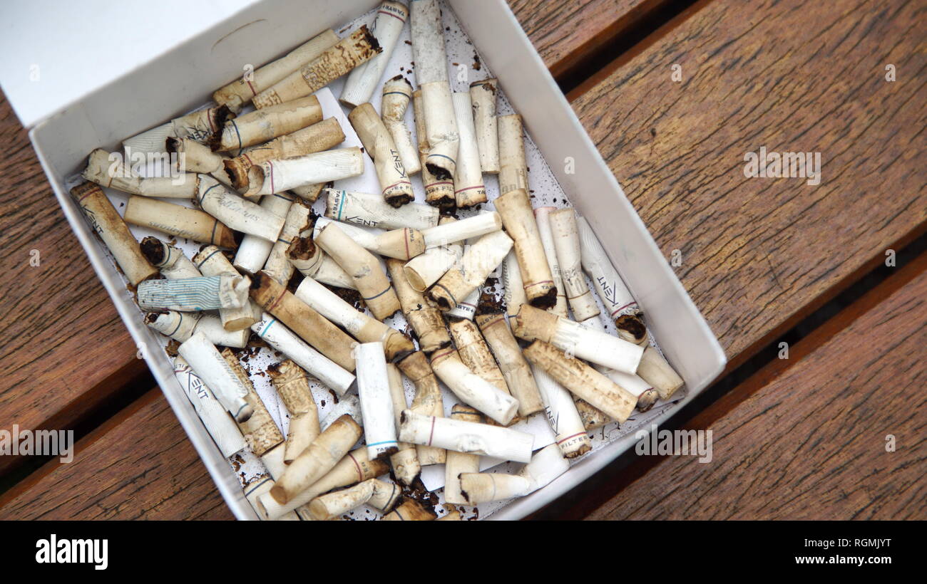 Bunch of Cigarette Butts inside a box Stock Photo - Alamy
