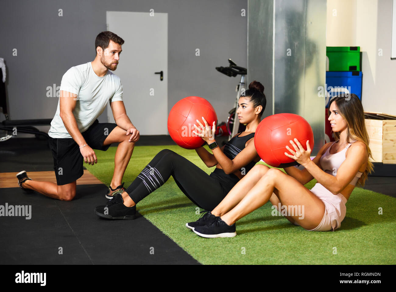 Young people doing ab training with fitness balls Stock Photo - Alamy