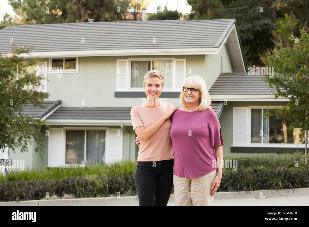 Portrait of smiling woman with mother in front of a house Stock Photo ...