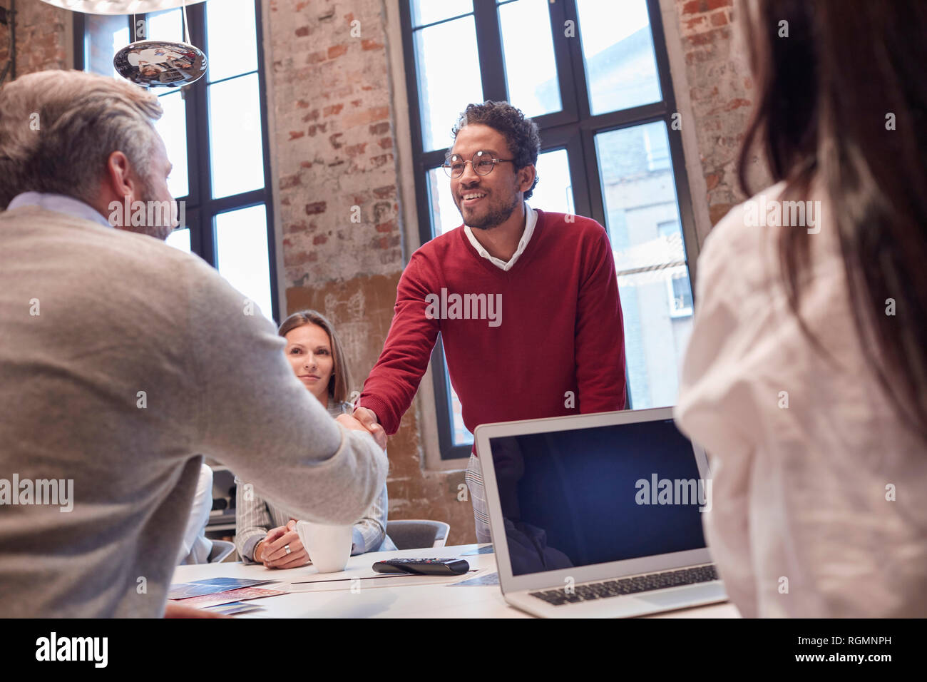 Colleagues greeting at a presentation in the office Stock Photo - Alamy