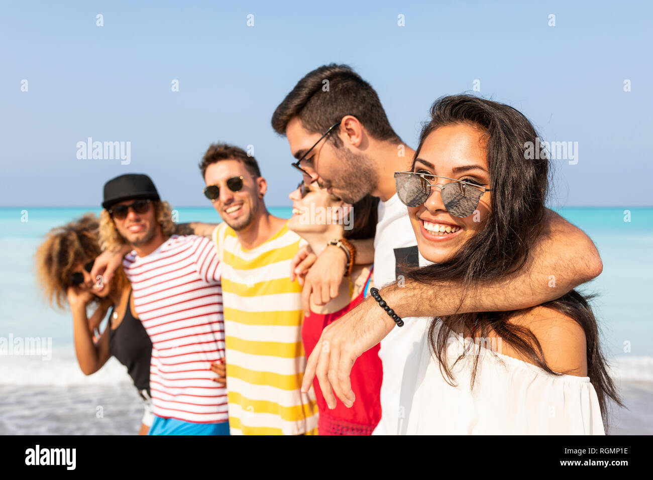 Group of friends walking on the beach Stock Photo - Alamy