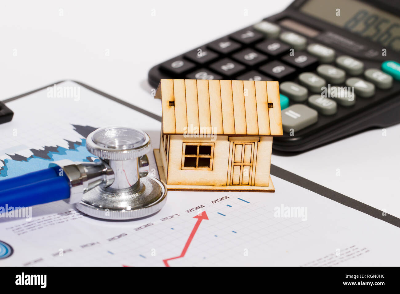 Small house with stethoscope, real estate analysis and price increase ...