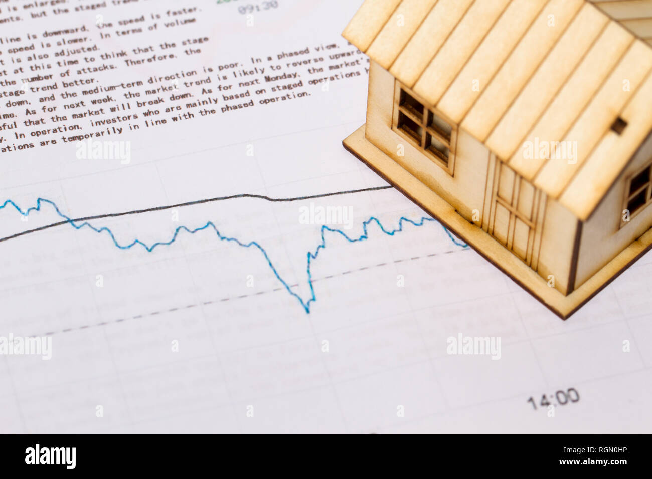 Small house with economic charts, real estate analysis Stock Photo - Alamy
