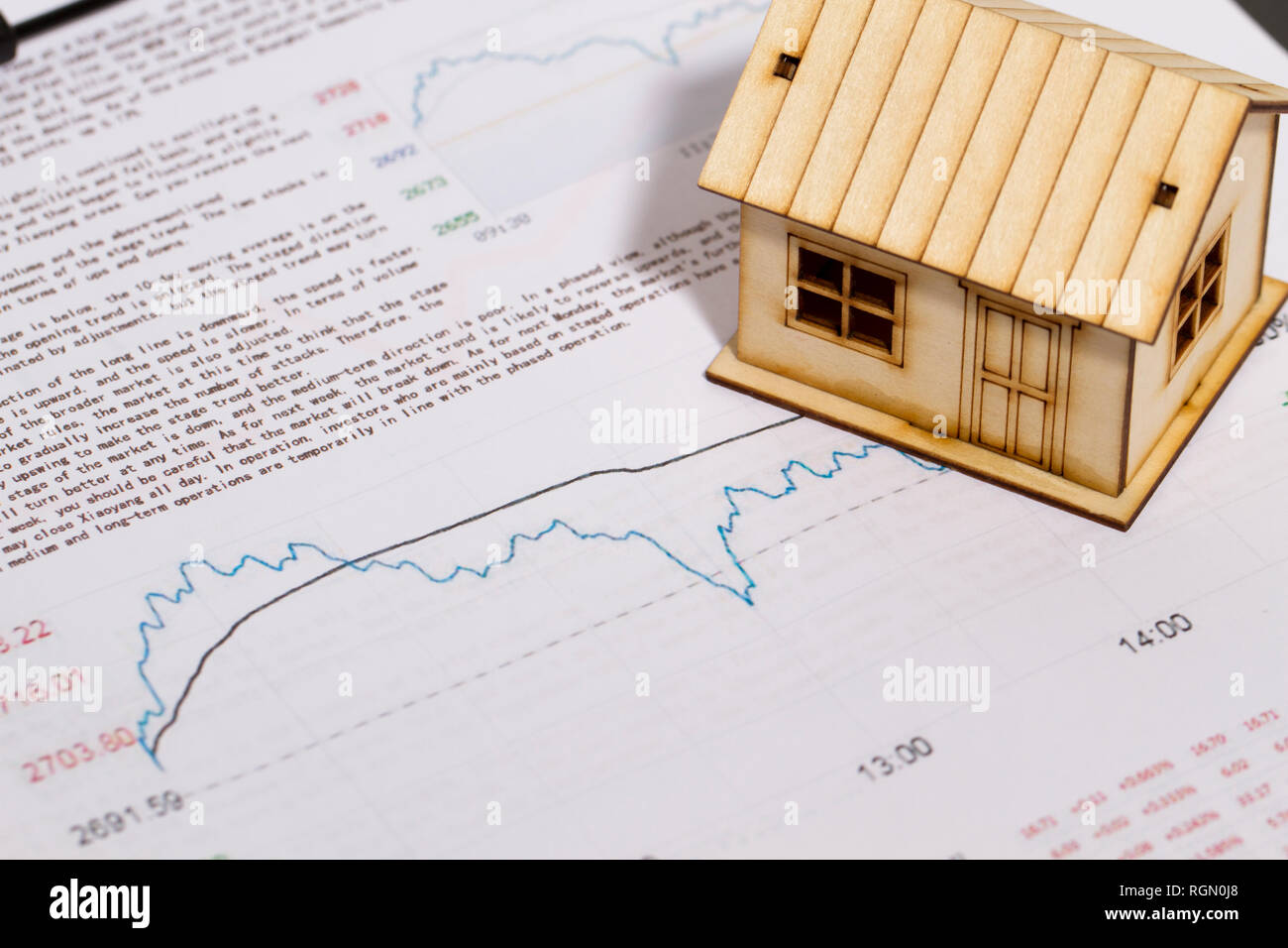 Small house with economic charts, real estate analysis Stock Photo - Alamy
