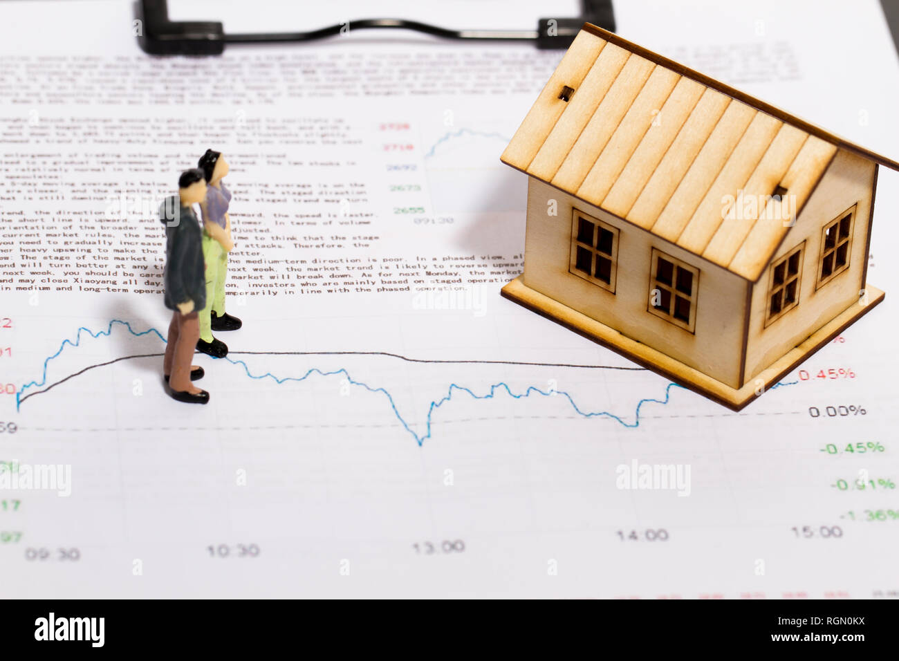 Small house with economic charts, real estate analysis Stock Photo - Alamy