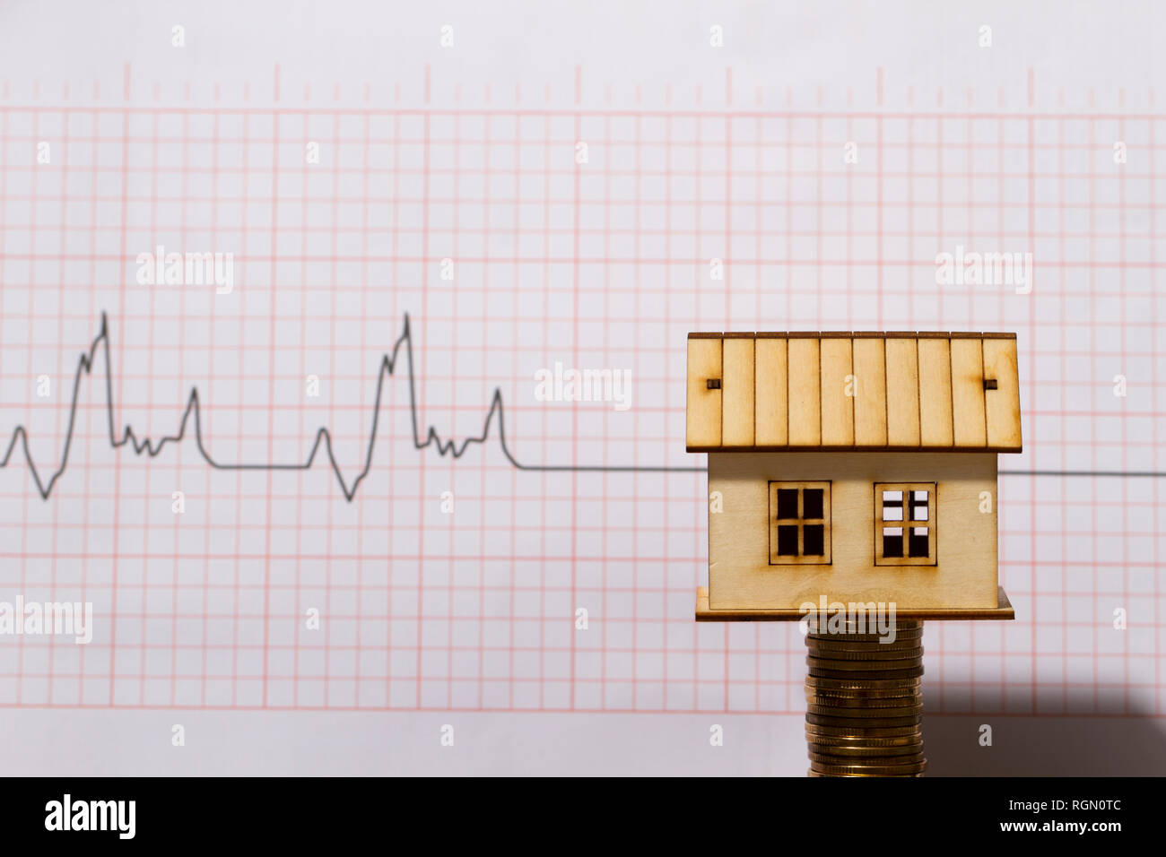 Small house with economic charts, real estate analysis Stock Photo - Alamy