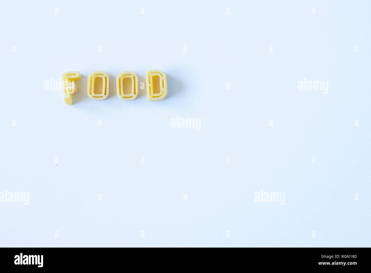 The word "food" composed with real pasta letters on a white surface ...