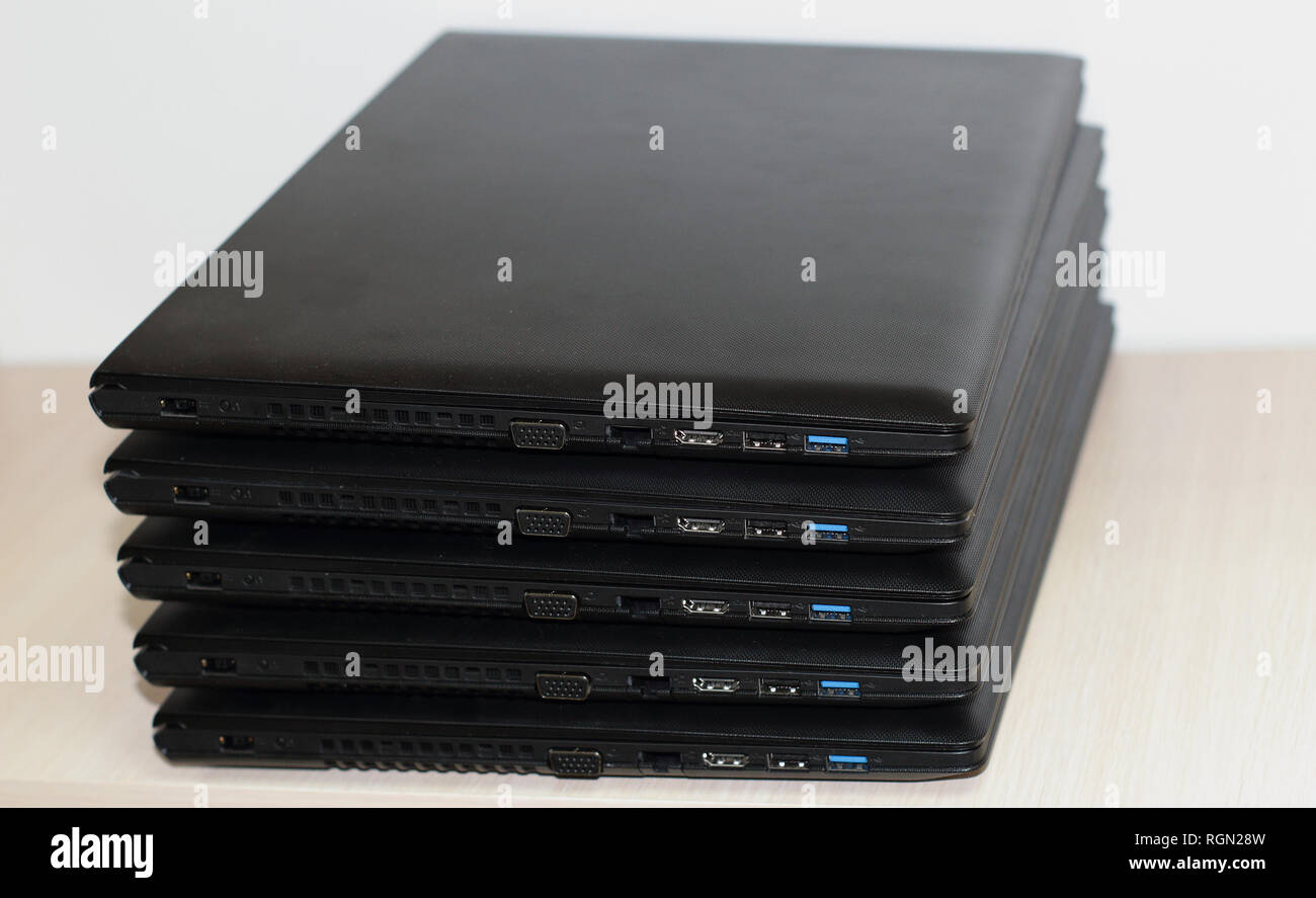 Folded Stack Of Laptops On White Background Stock Photo - Alamy