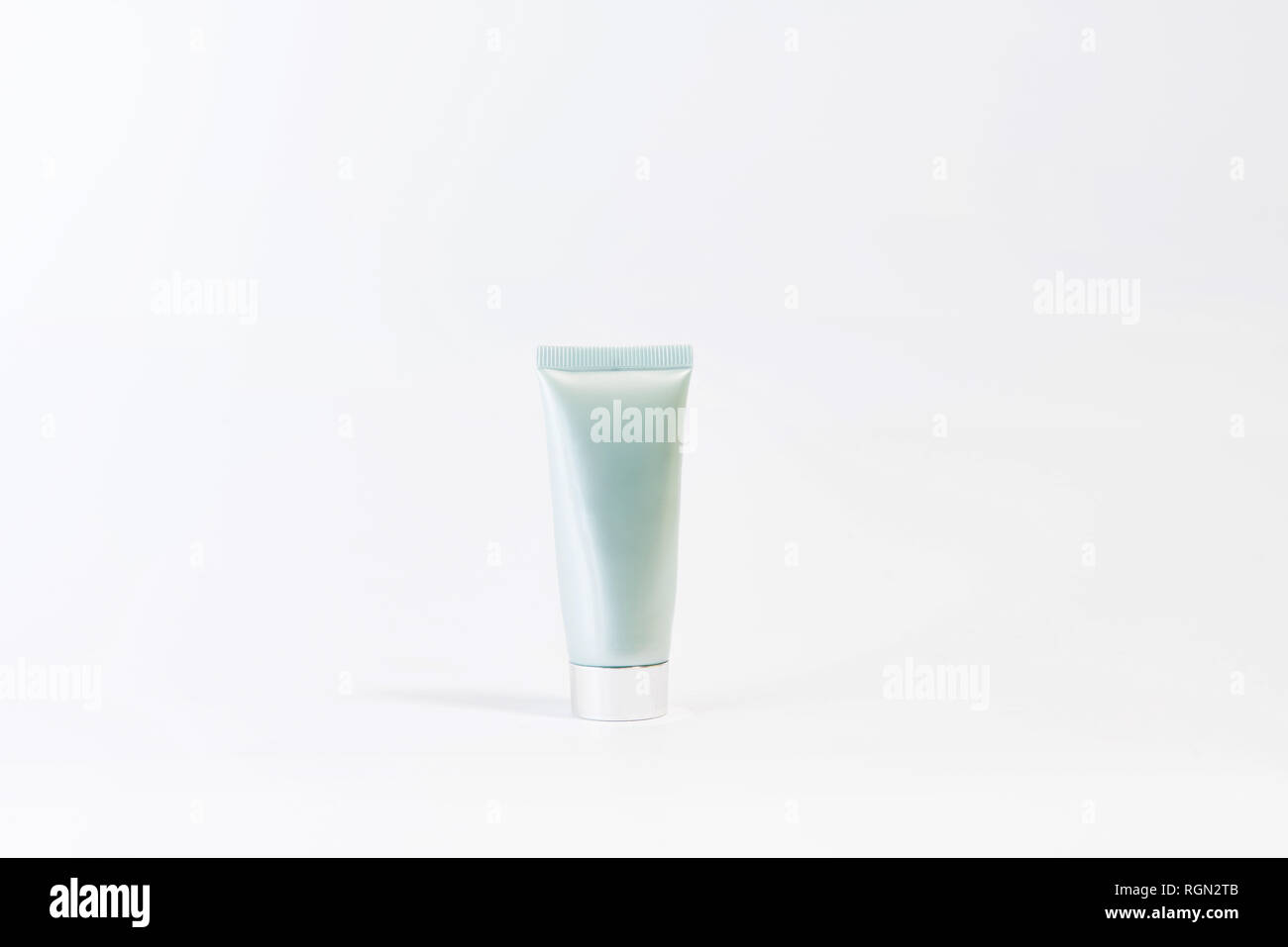 Blank plastic hand cream bottle on white background. Copy space for ...