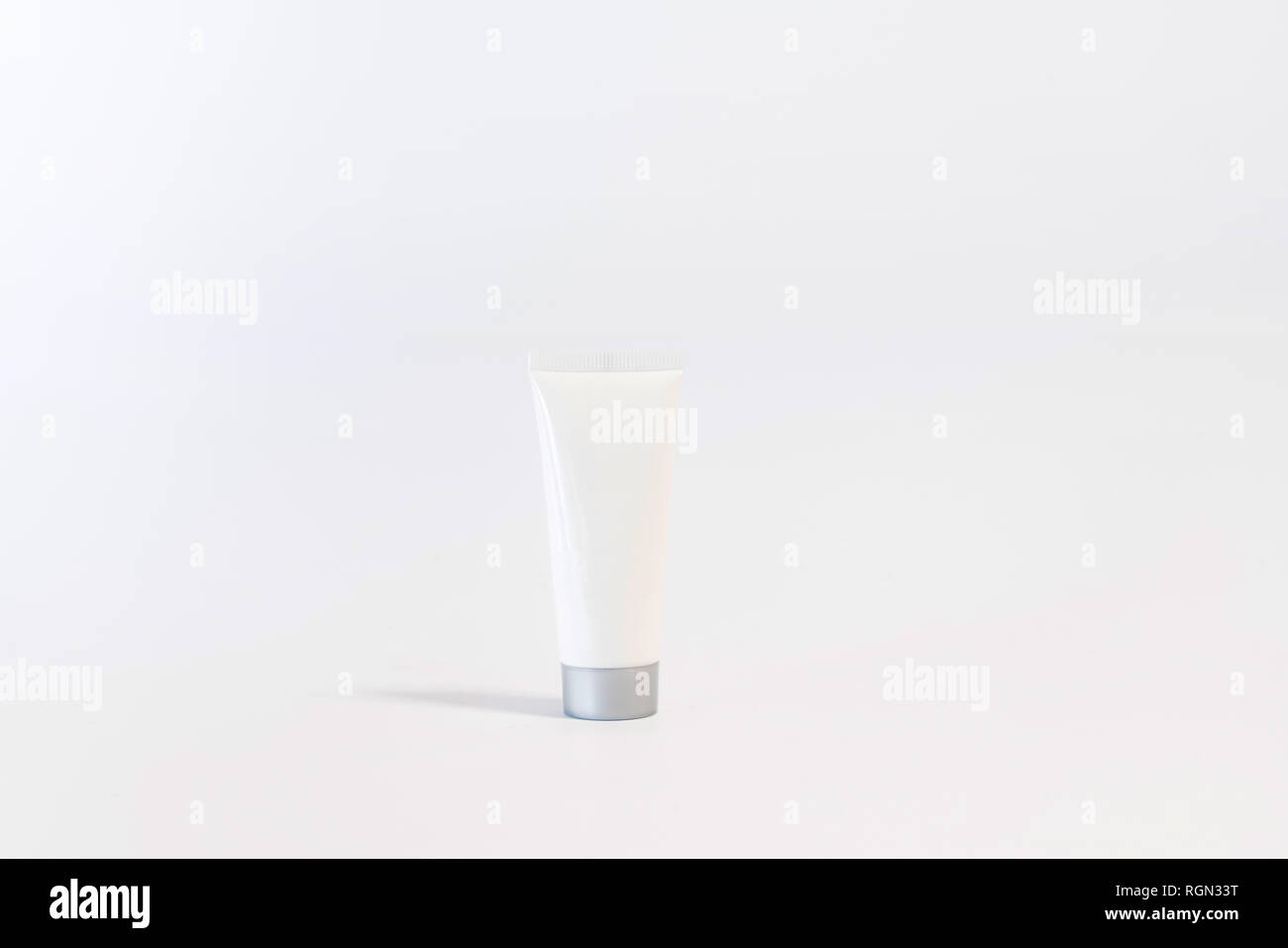 Blank plastic hand cream bottle on white background. Copy space for ...