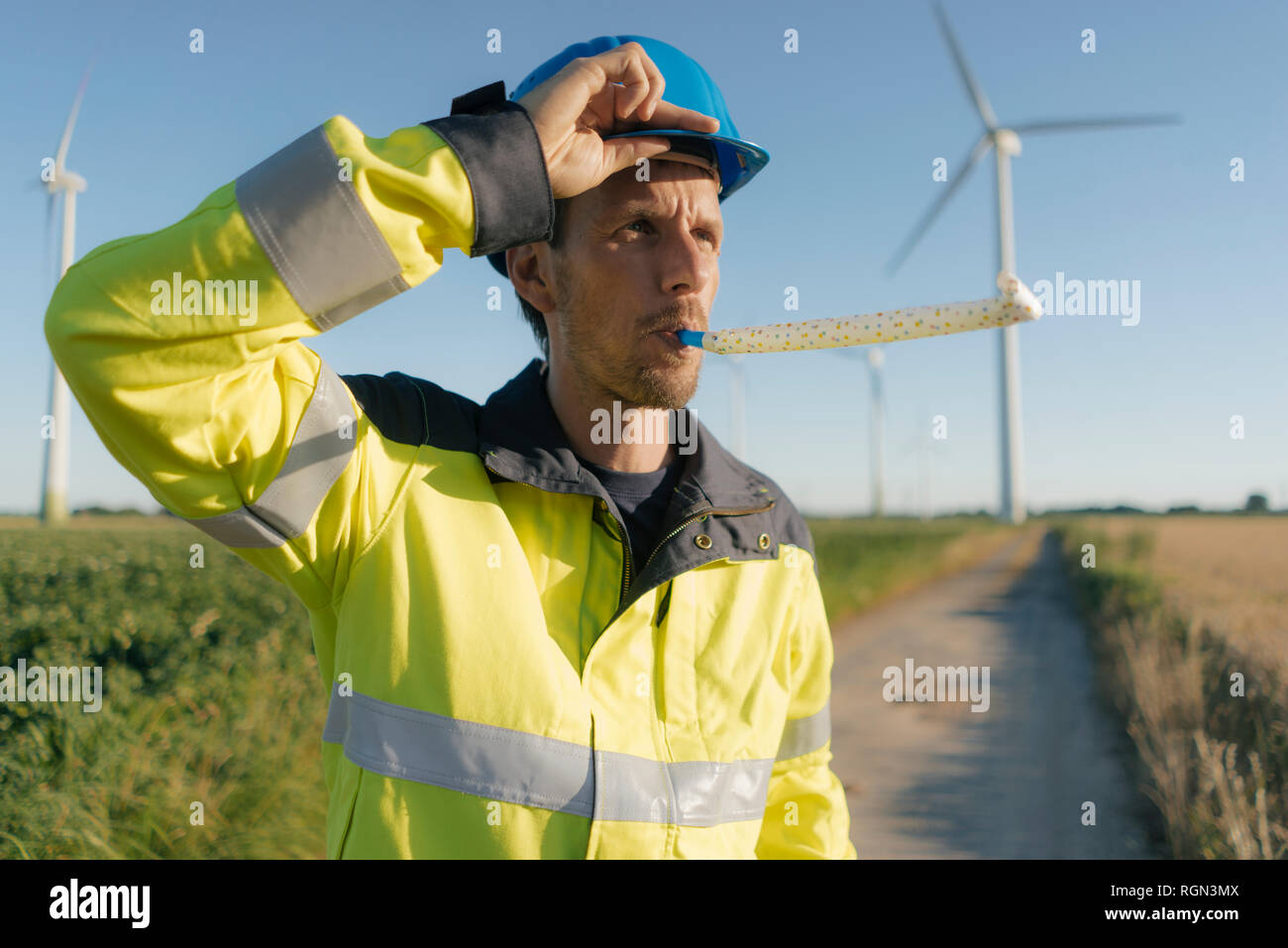 Portrait of an engineer with party blower at a wind farm Stock Photo ...