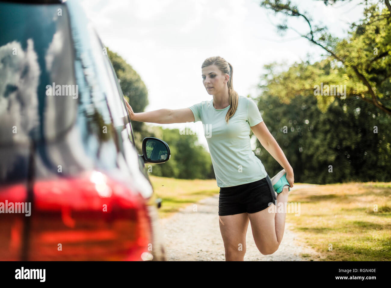 Stretching woman car hi-res stock photography and images - Alamy