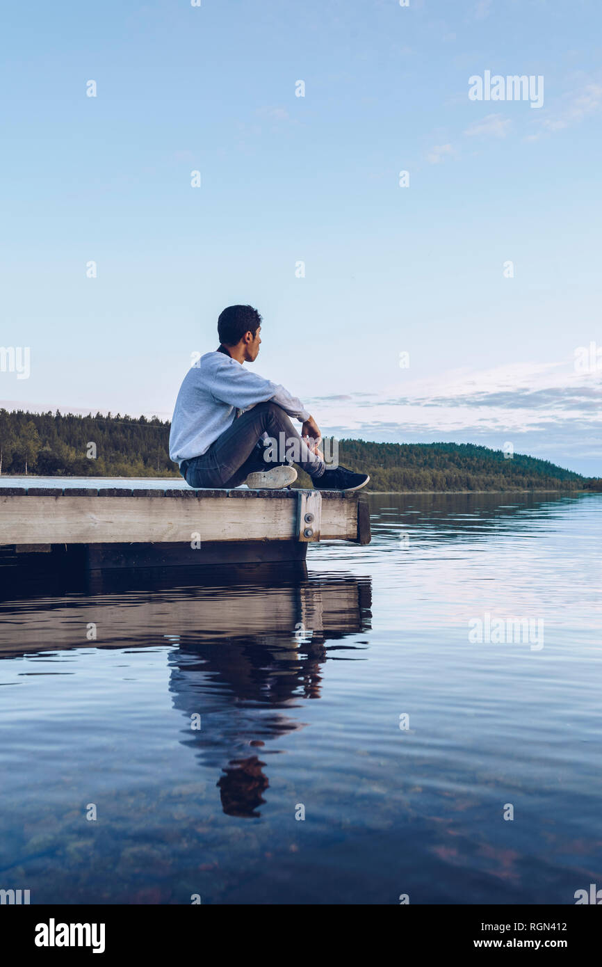 Side view young man sitting hi-res stock photography and images - Alamy