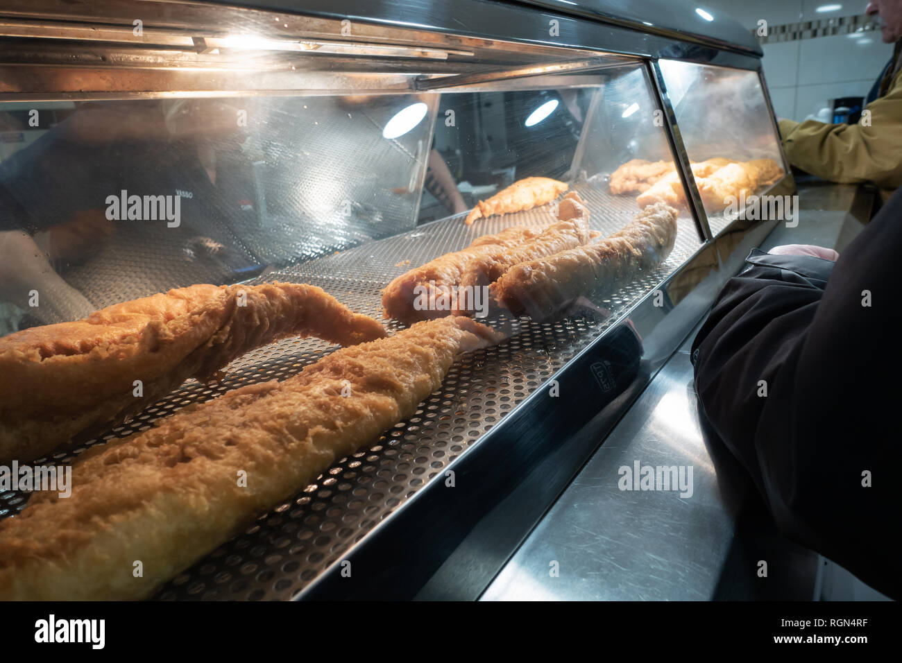 Freshly cooked fish on display in an English Fish and Chip shop Stock ...
