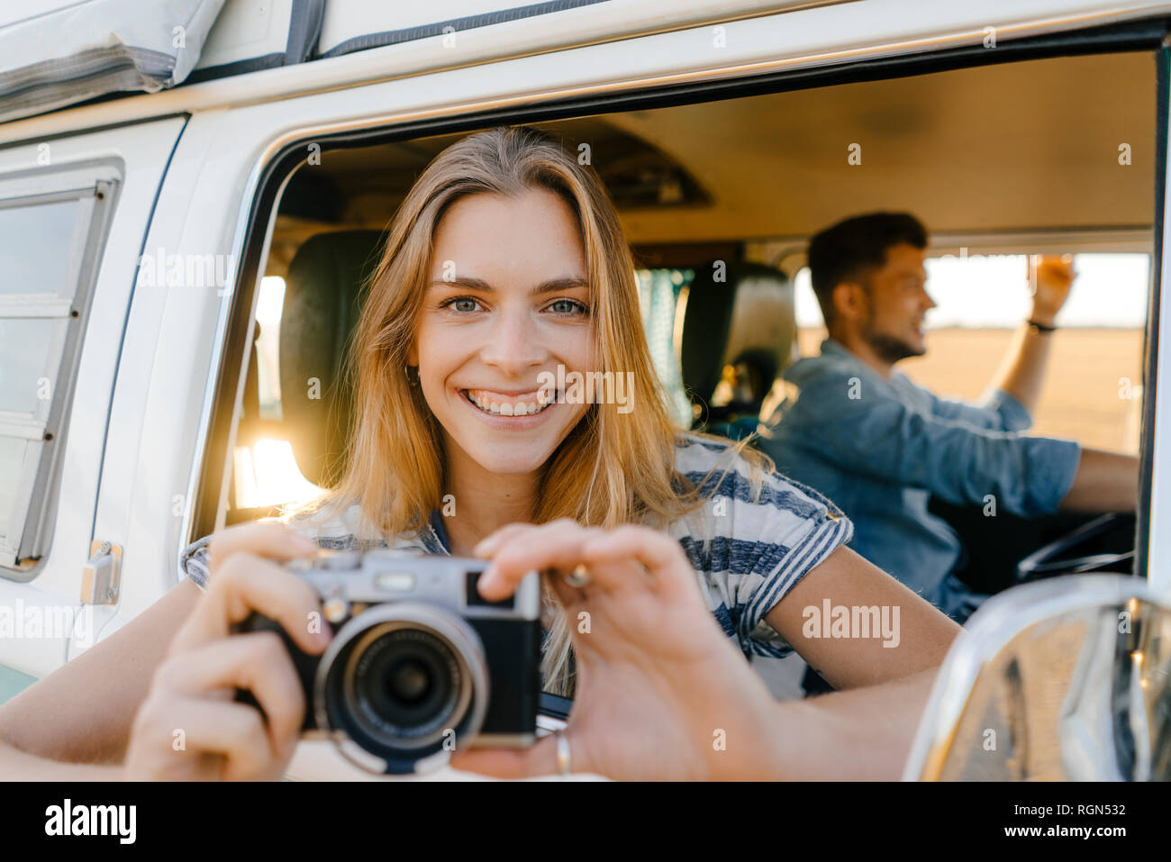 Young woman leaning out window camper van hi-res stock photography and ...