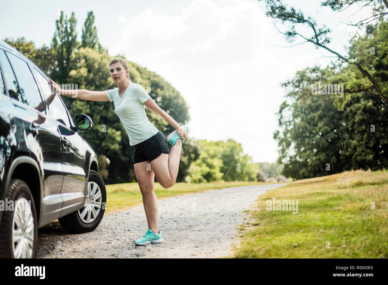 Stretching woman car hi-res stock photography and images - Alamy
